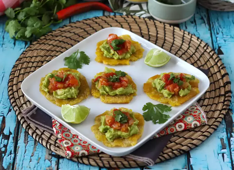 Patacones, Colombian plantain toast with guacamole and tomatoes