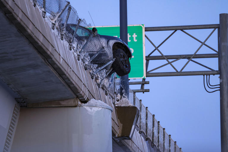Truck dangling over barrier of I-93 near Zakim Bridge in Boston: Photos