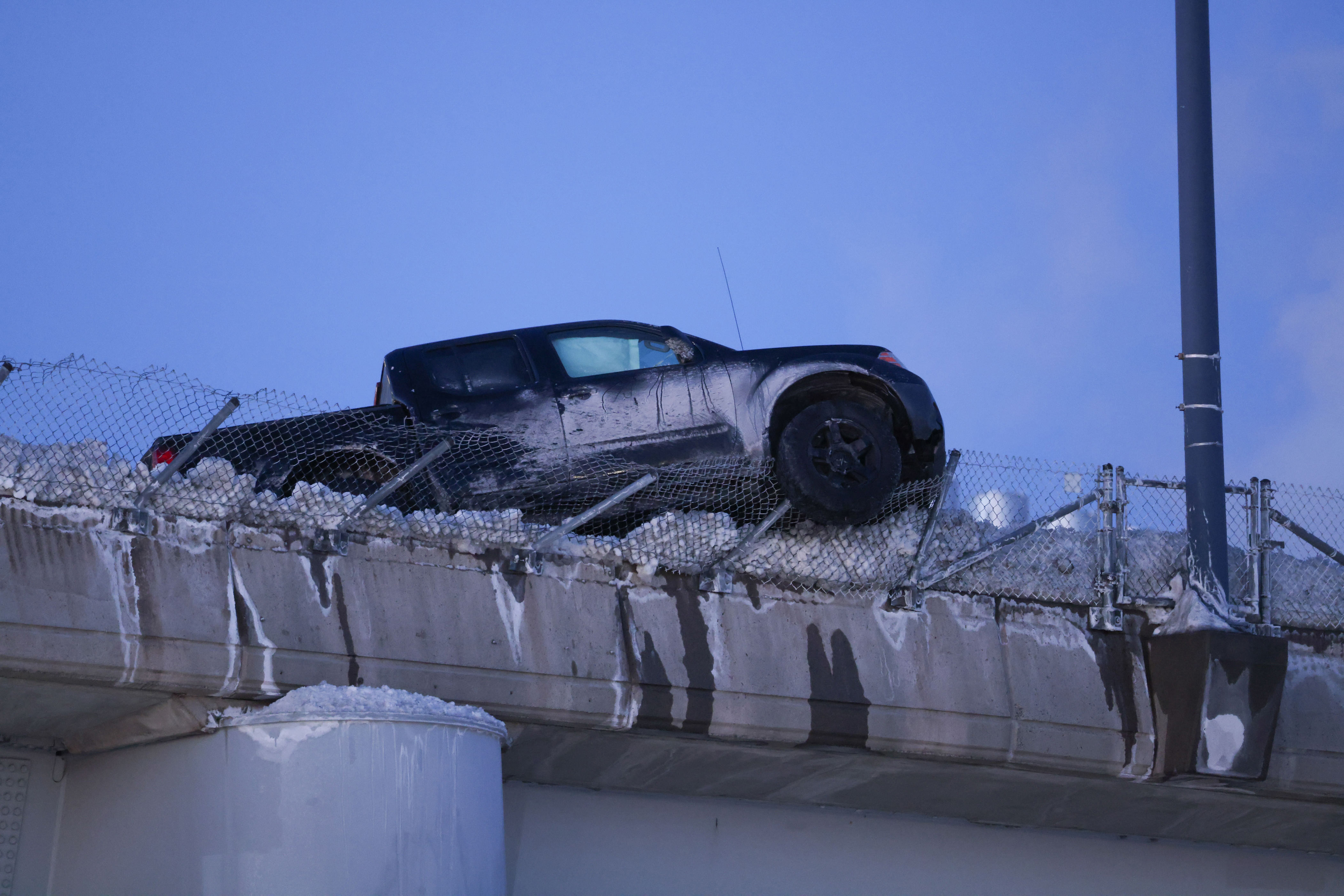 Truck dangling over barrier of I-93 near Zakim Bridge in Boston: Photos