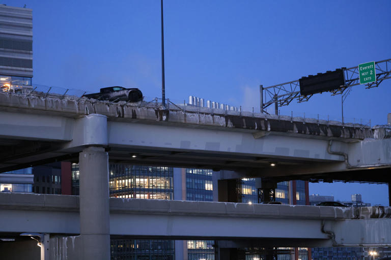Truck dangling over barrier of I-93 near Zakim Bridge in Boston: Photos