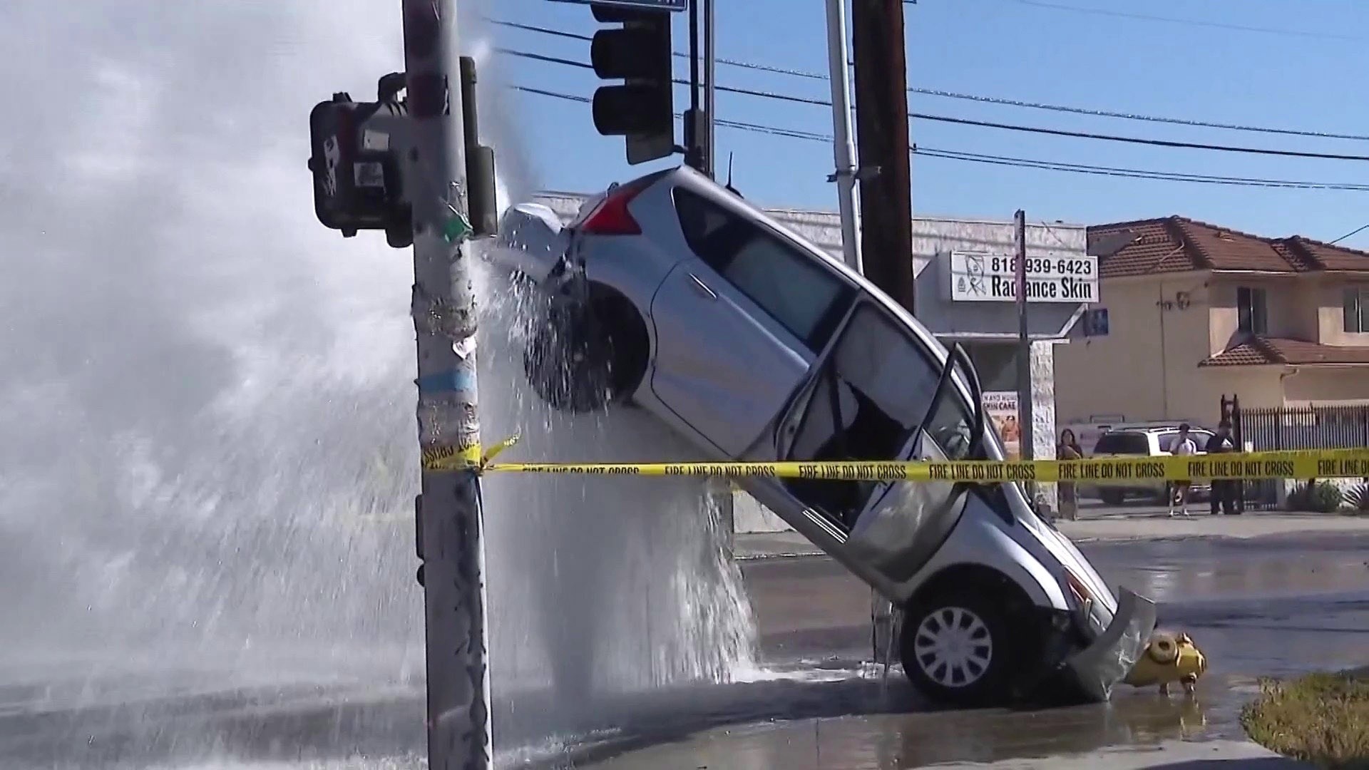 Car crashes into fire hydrant, water lifts vehicle into the air