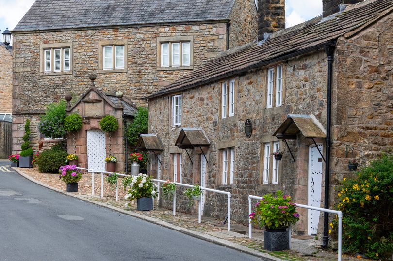 Medieval chocolate box village with stone cottages and Britain's oldest ...