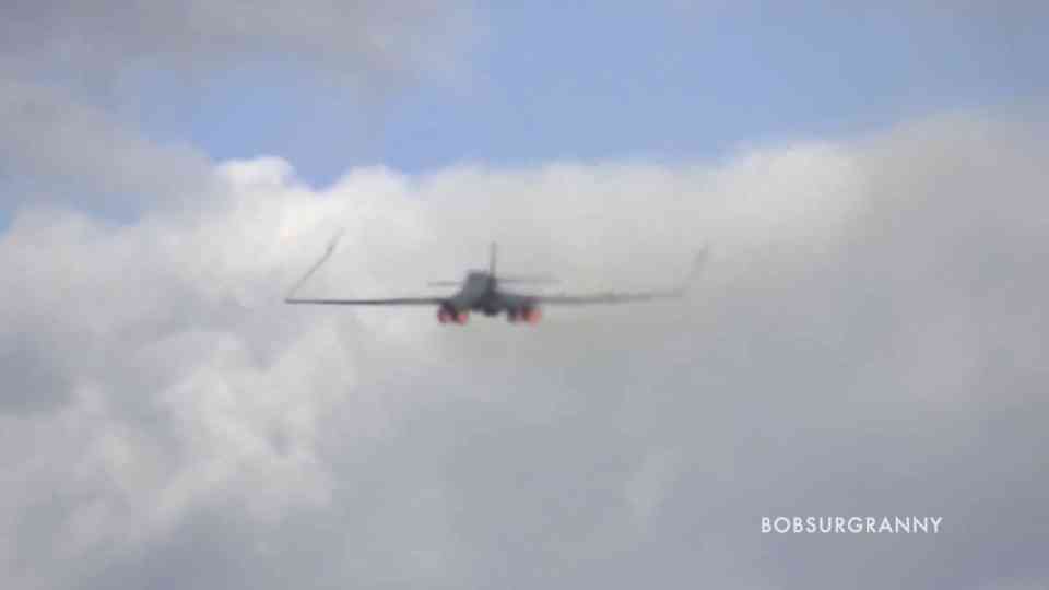 Thunderous B-1B bomber takeoff with blazing afterburners overhead