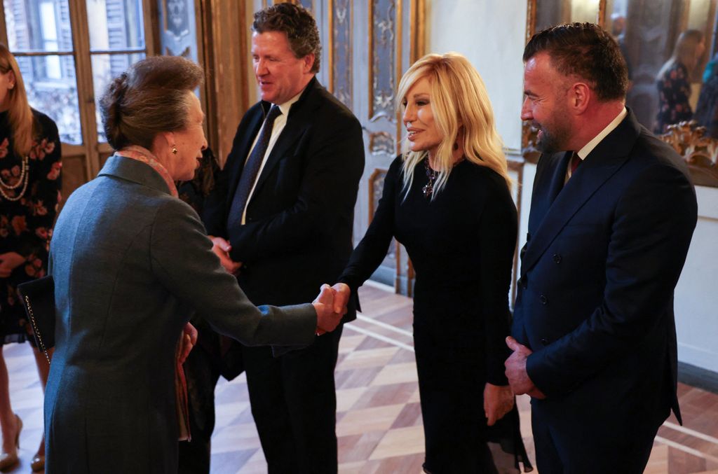 Princess Anne and husband Sir Timothy Laurence beam in matching scarves ...