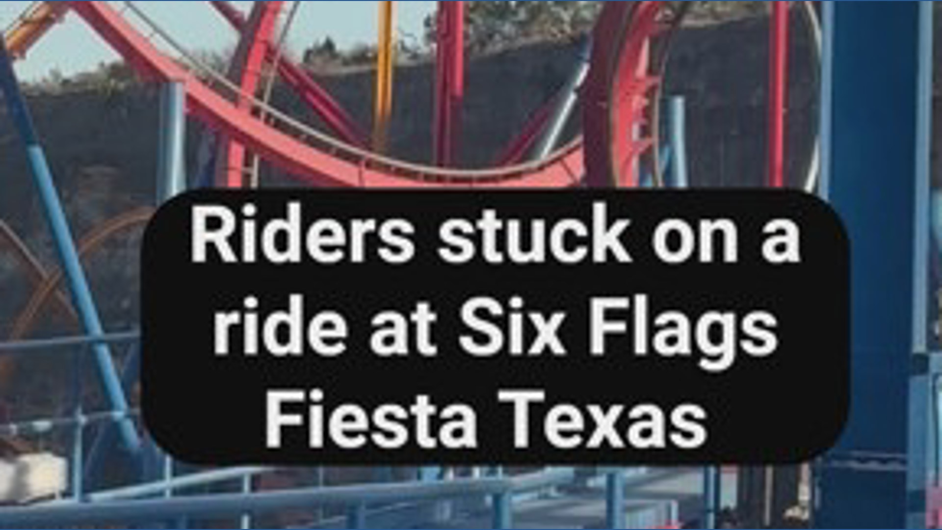 Riders get stuck on a ride at Six Flags Fiesta Texas on Saturday