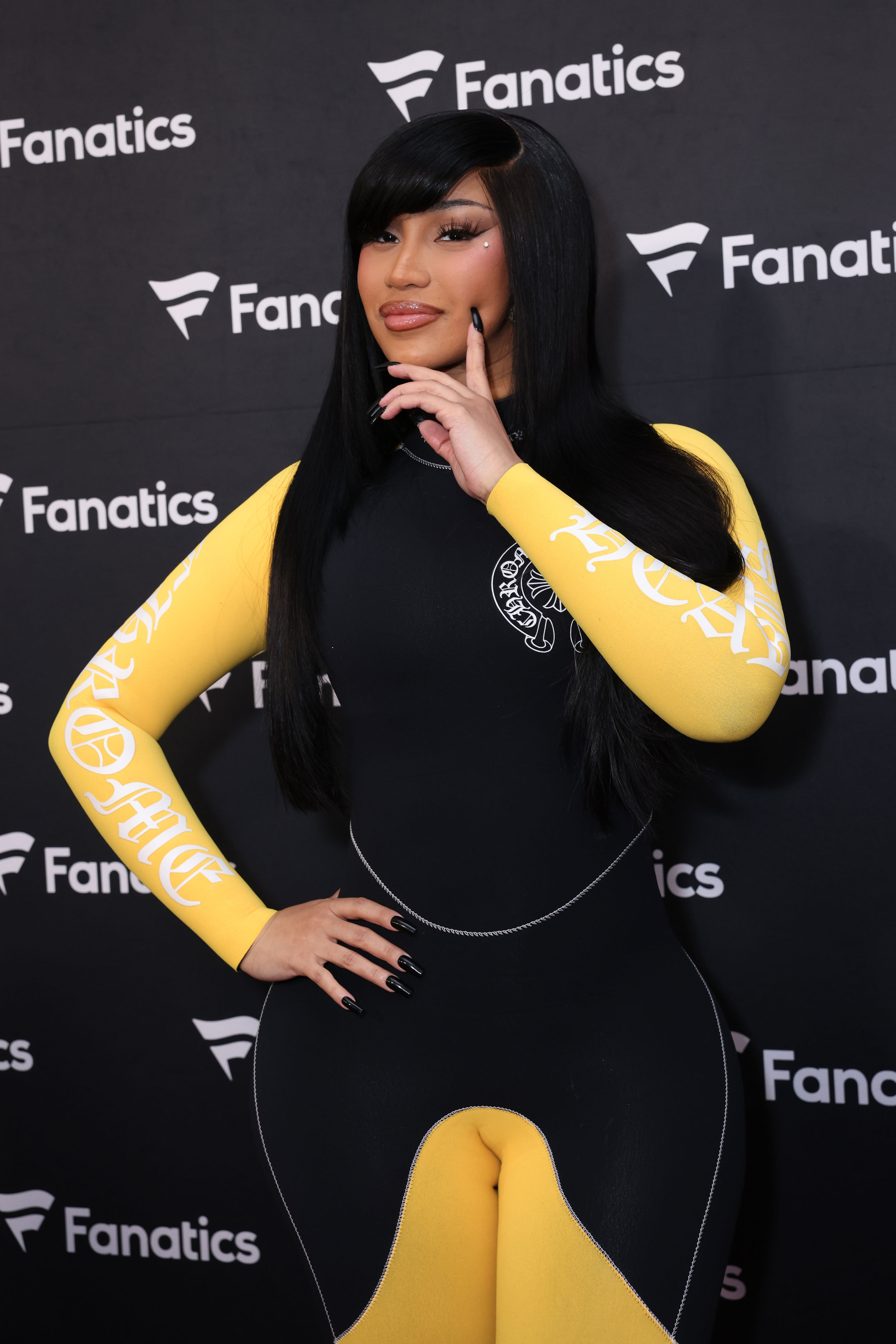 Cardi B takes a tumble while giving a robot a lap dance
