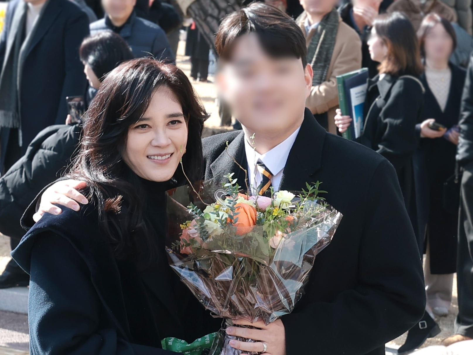 Hotel Shilla president Lee Boo-jin smiles at son's graduation