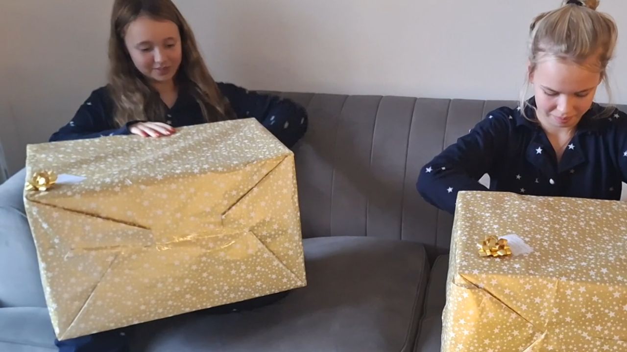 Girls scratch Etsy reveal card and find out they're heading to America