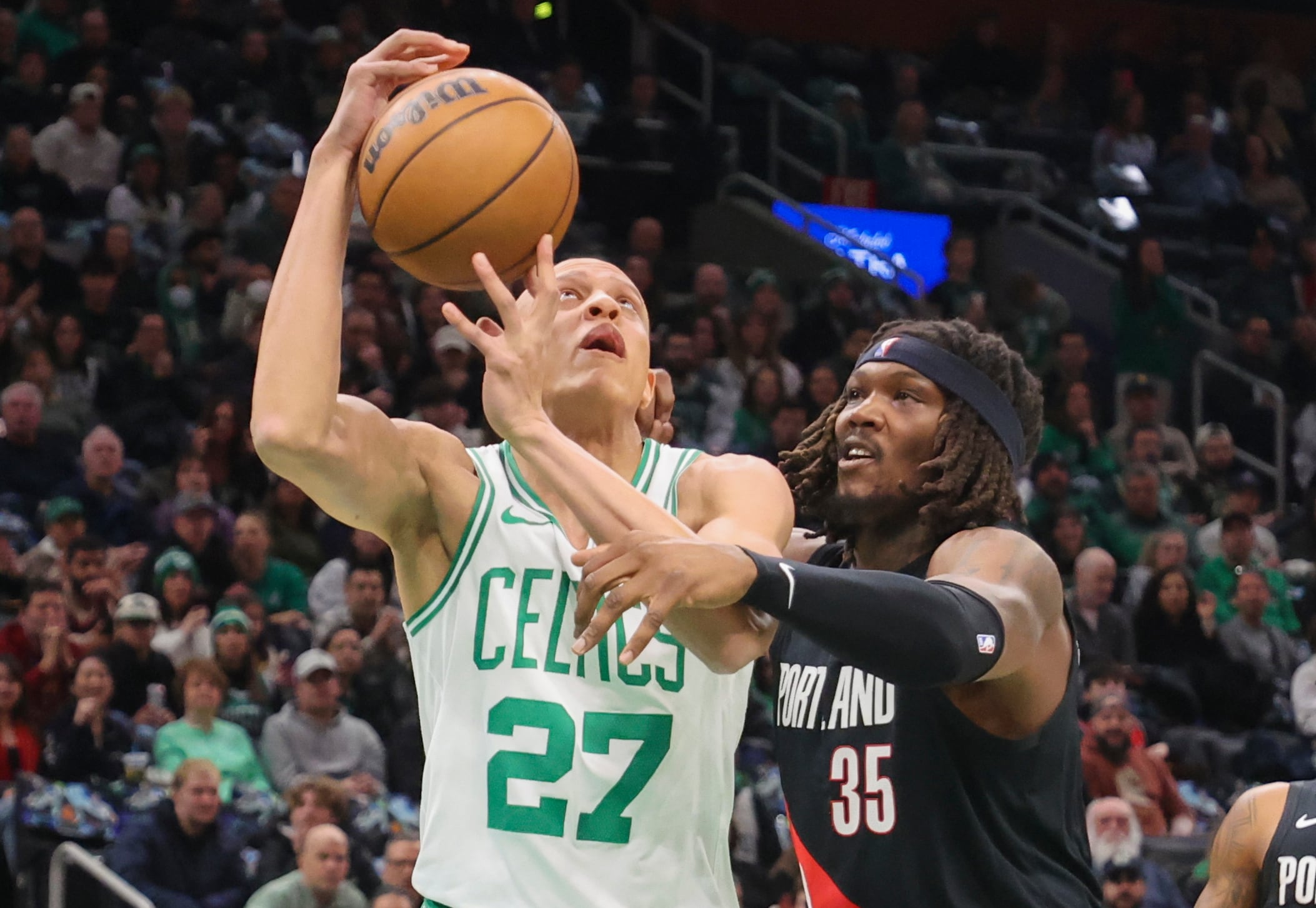 Jrue Holiday and Rob Williams return to Boston in stylish walk down ...