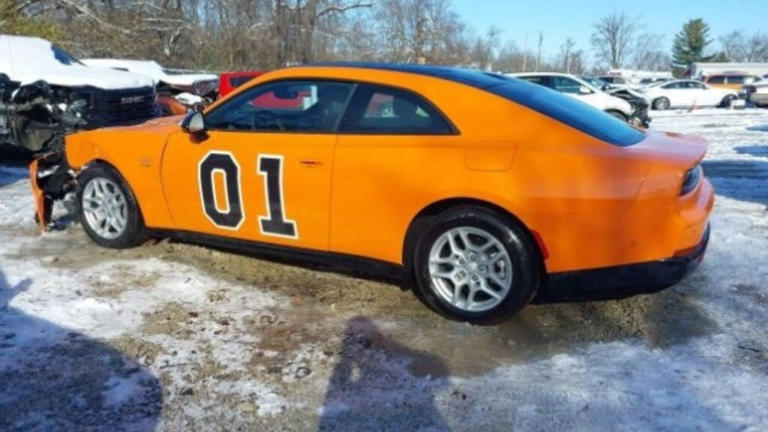Crashed 2025 Dodge Charger Daytona General Lee sitting in junkyard