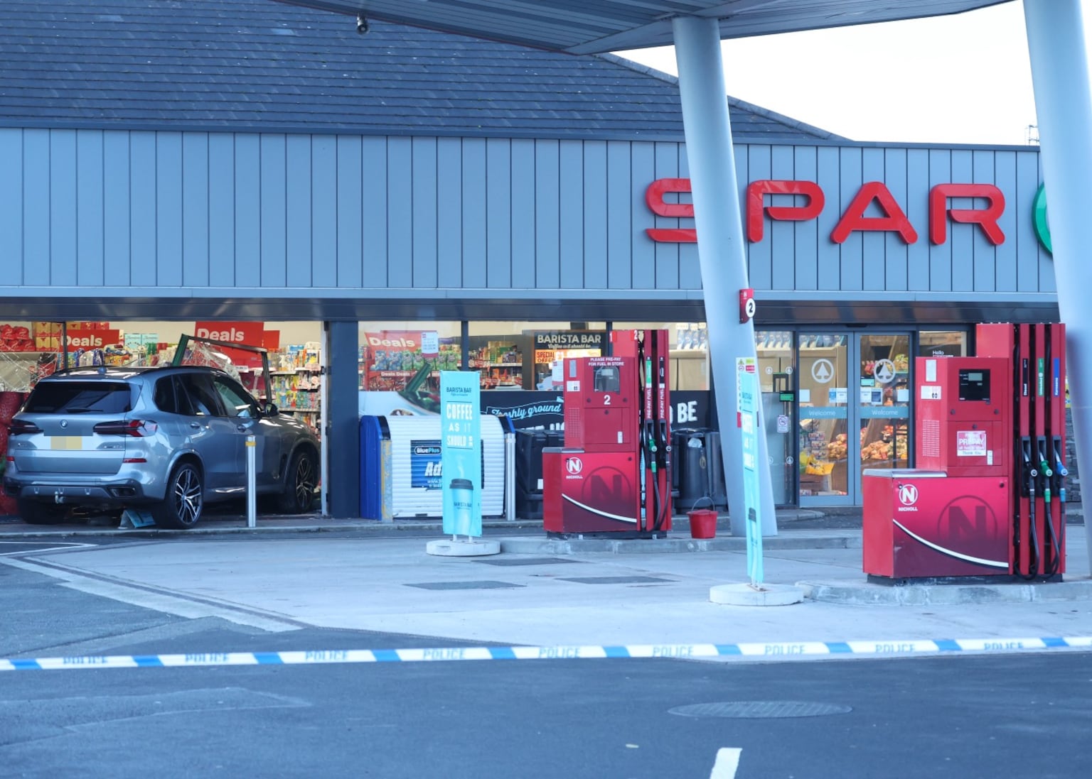 Local community stunned as man dies after car crashes through shop ...