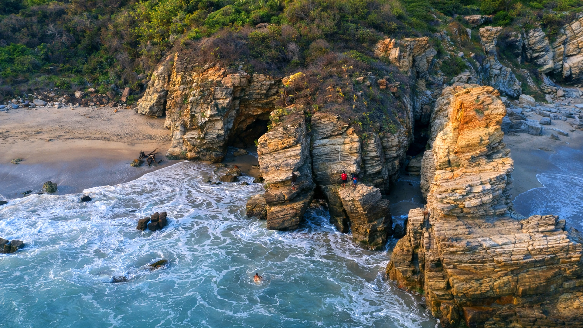 Zicatela Beach with rugged cliffs and crashing waves