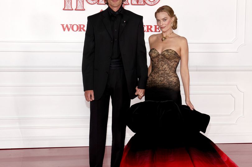 Margot Robbie sizzles in plunging corset dress as she turns heads on ...