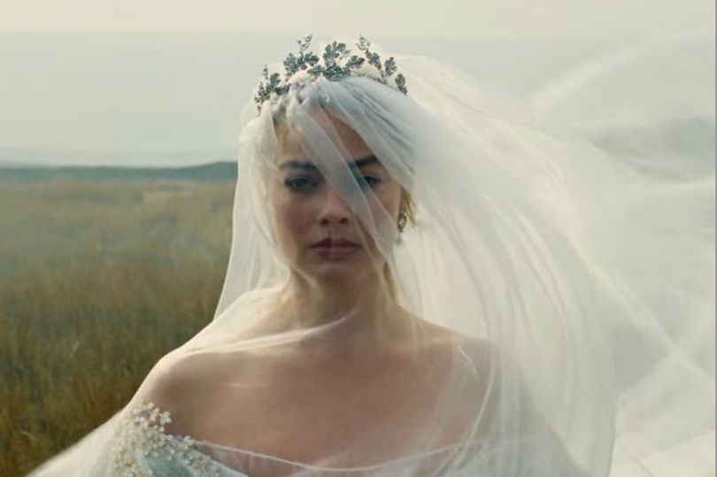 Margot Robbie sizzles in plunging corset dress as she turns heads on ...