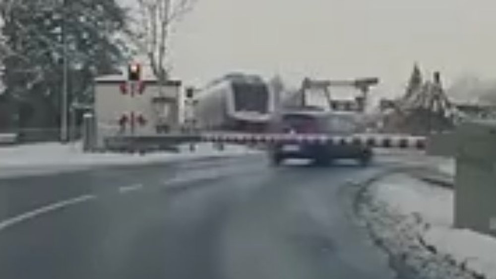 Driver ignores barrier and is hit by train