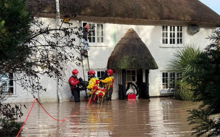 Man and dog rescued from upstairs of flooded home