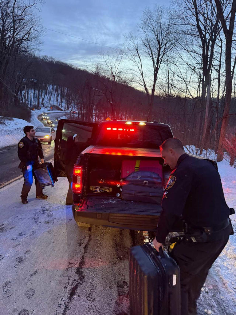 Police save luggage spilling from coach bus while escorting cheer team ...
