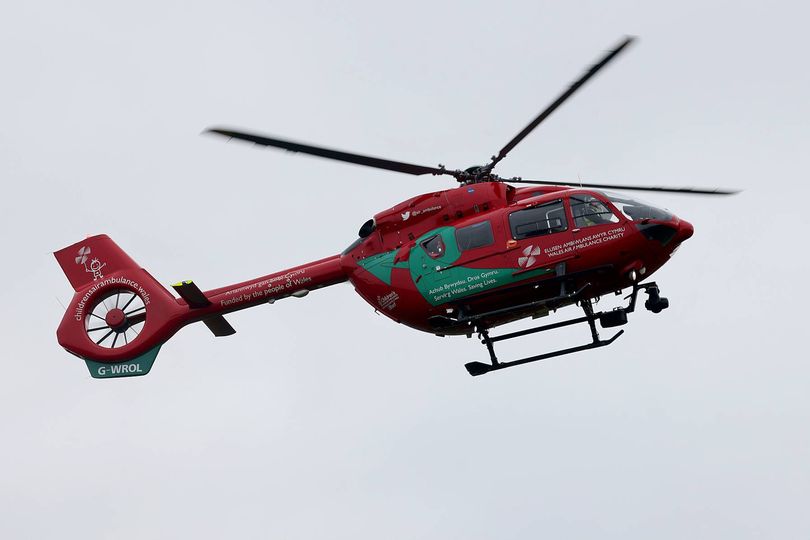 Road closed after crash, with air ambulance at scene