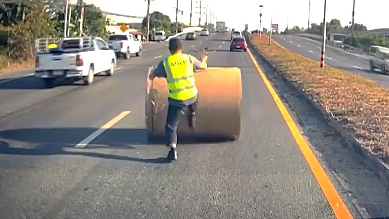Huge paper roll barrels into traffic, knocking man down in Thailand