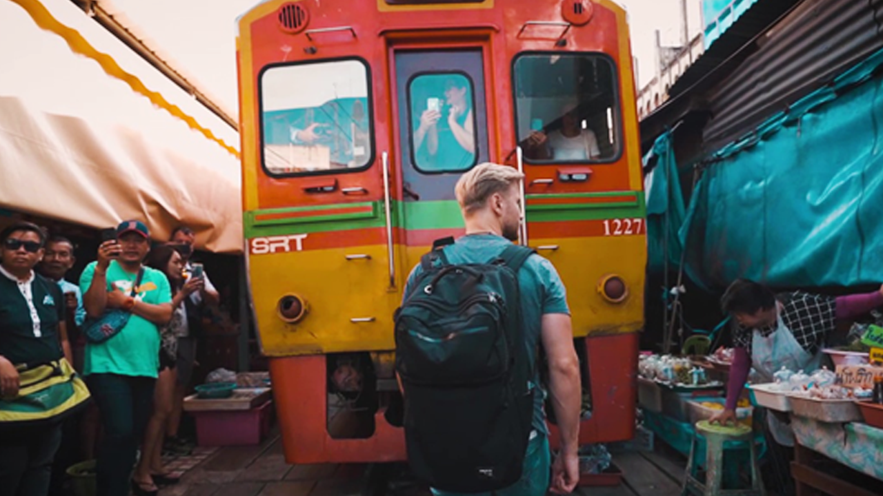 Footage of train passing through the famous Maeklong Railway Market