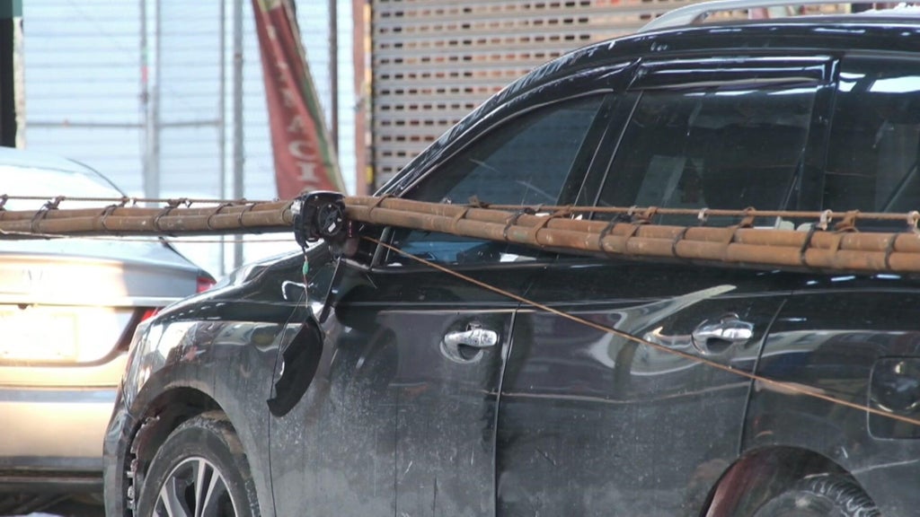Wires fall from elevated subway tracks in Brooklyn onto cars below