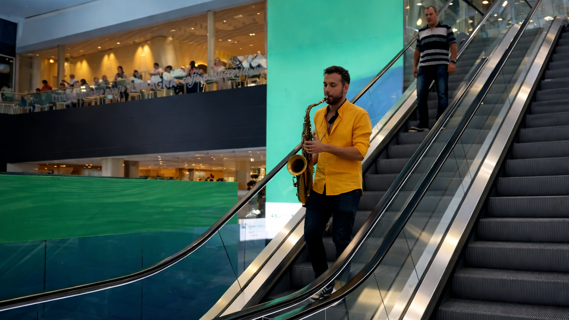 A saxophonist joins in from the escalator