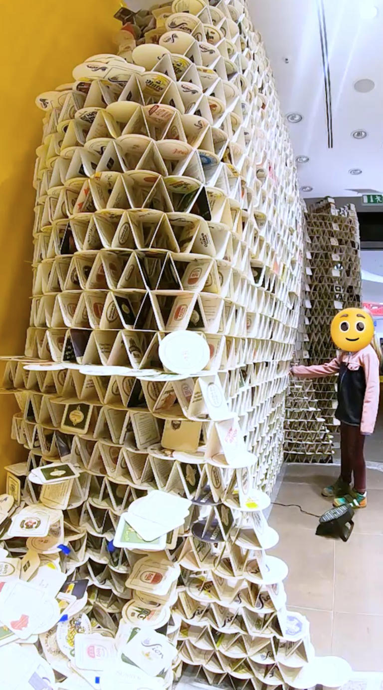 Young girl topples tower made from 63,000 beer coasters created by ...
