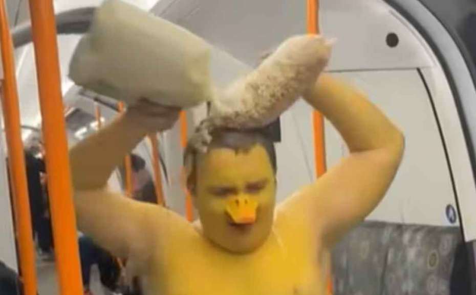 Man dressed as duck pours milk and cereal over himself in subway train