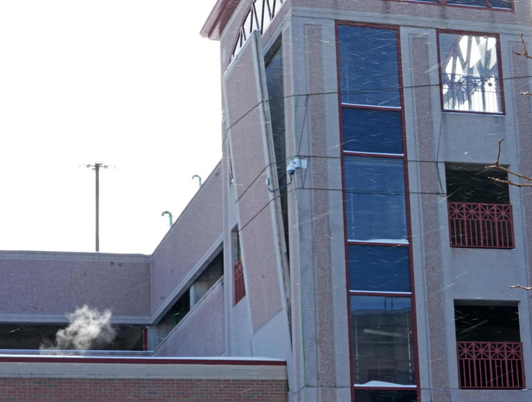 Wall held together by cables on 10th Street garage. What happened?