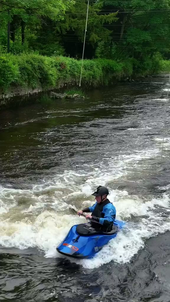 Freestyle kayak tricks on a local river wave