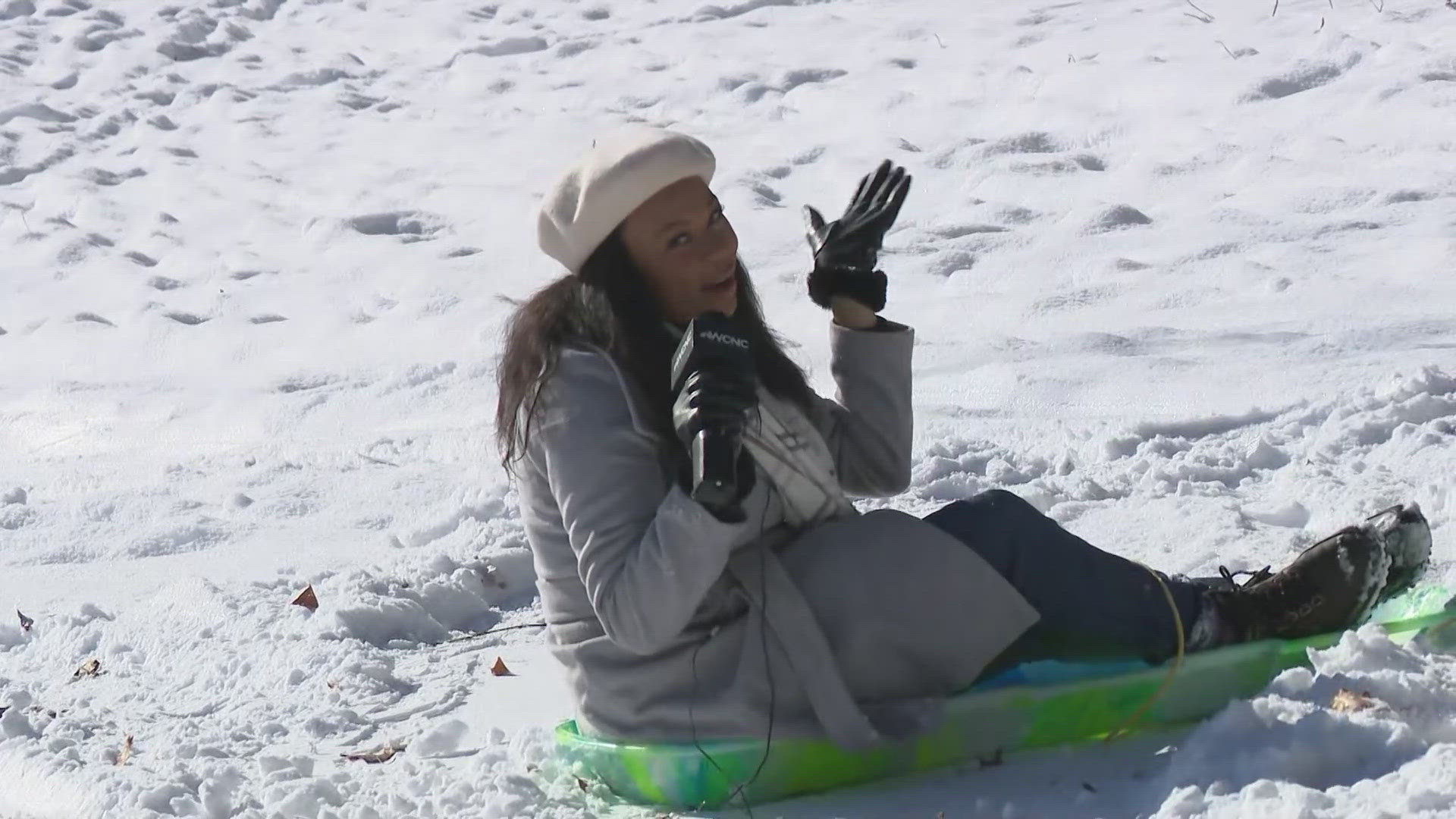Family helps Autumn Bracey with her sledding skills at Freedom Park