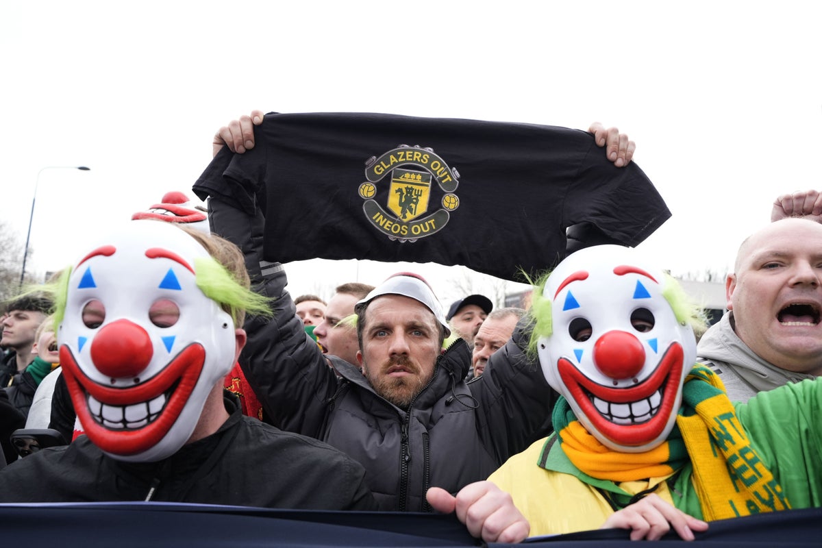 Man United fans wear clown masks in latest protest against owners