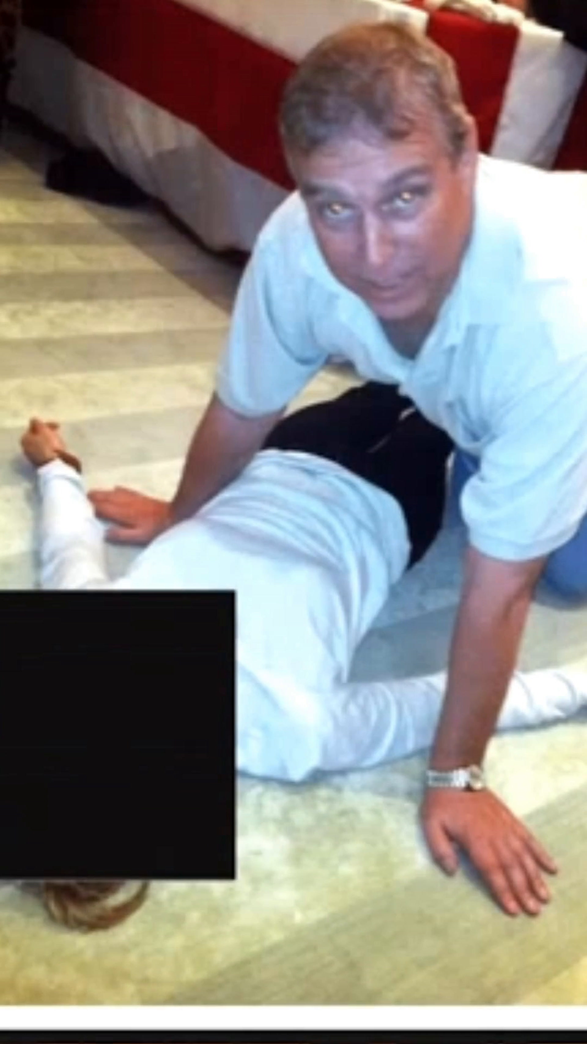 Photos from Epstein files appear to show Andrew on floor with woman