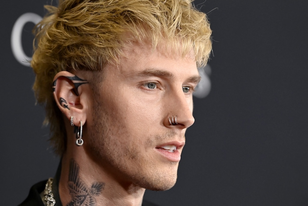 Machine Gun Kelly shows off new ear tattoos at Grammys 2026 party
