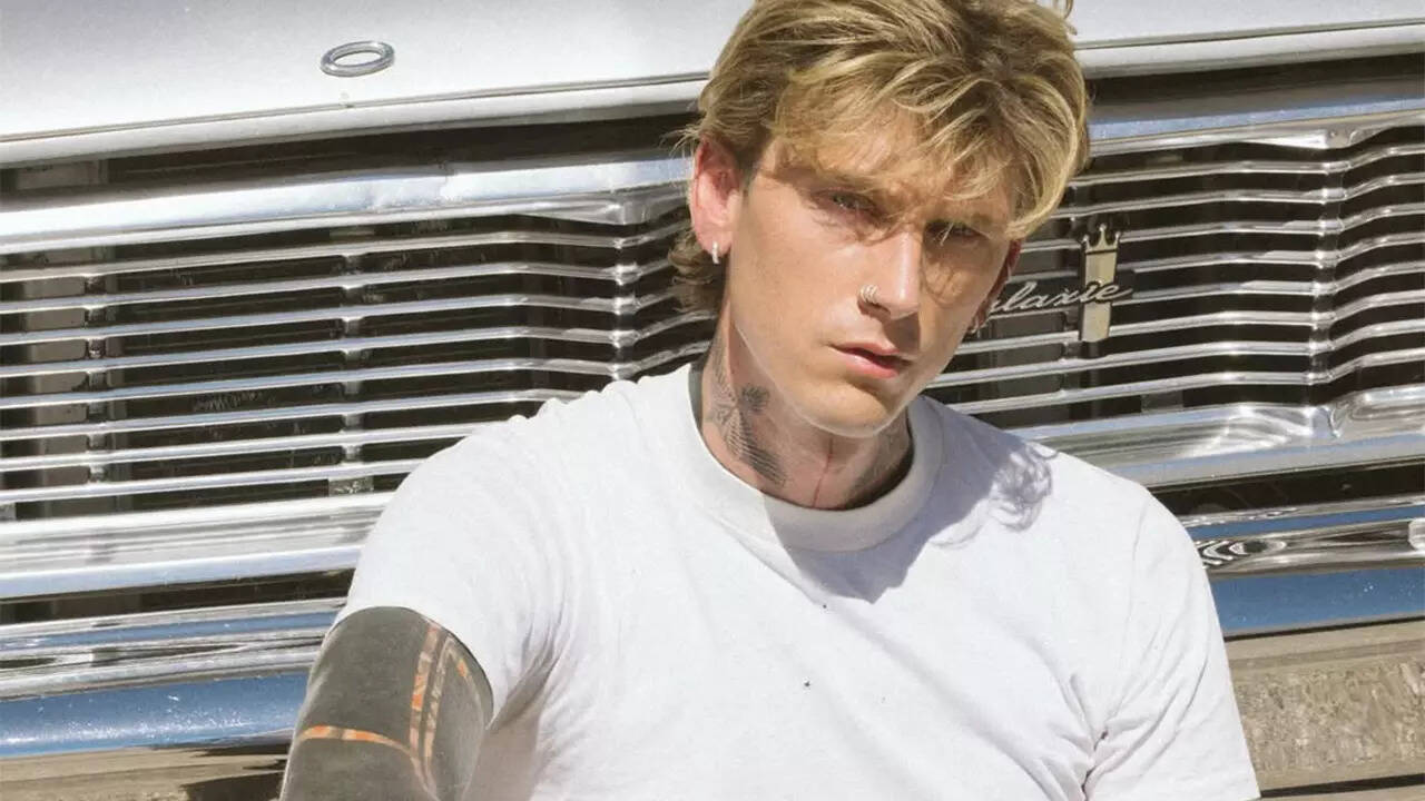 Machine Gun Kelly shows off new ear tattoos at Clive Davis Grammys party