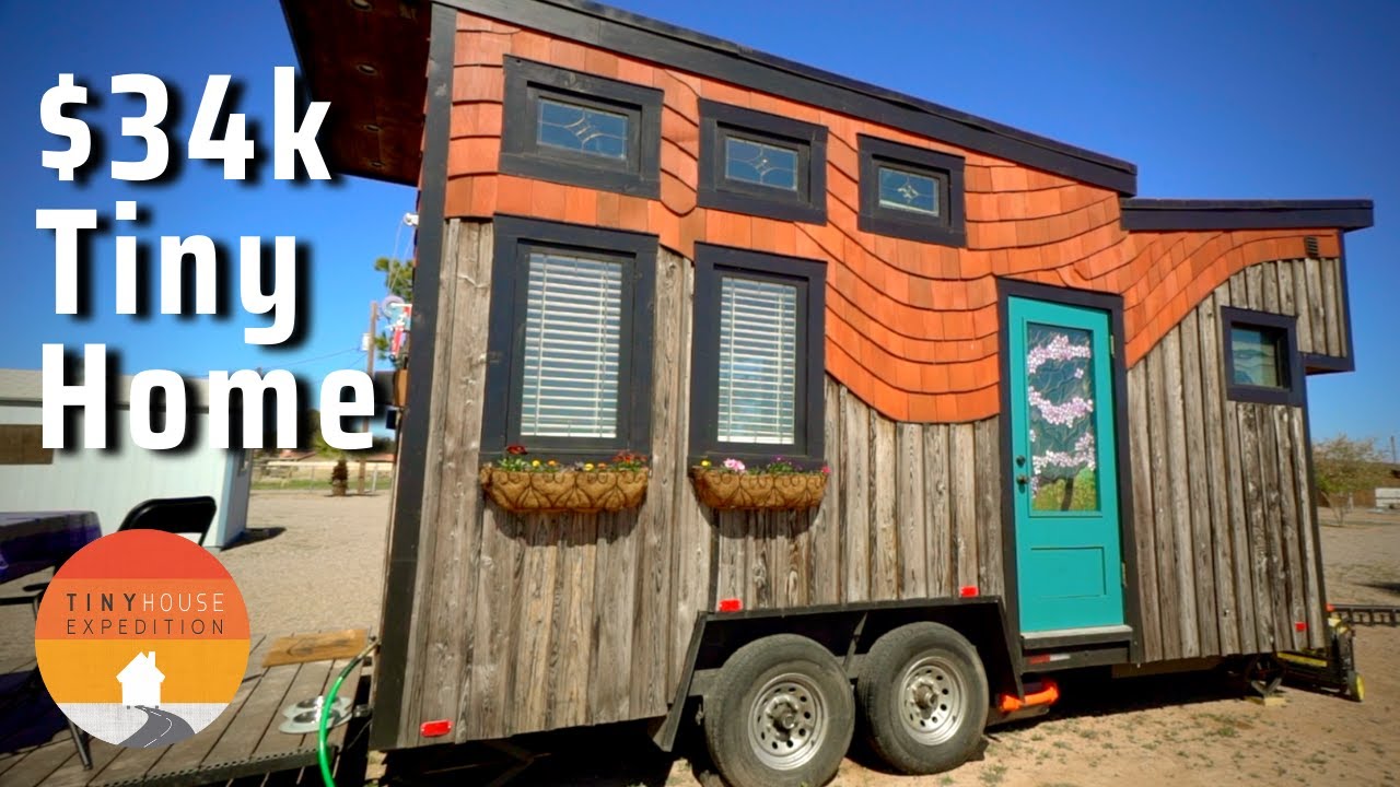 Striking handcrafted tiny house w/recycled materials & stained glass art