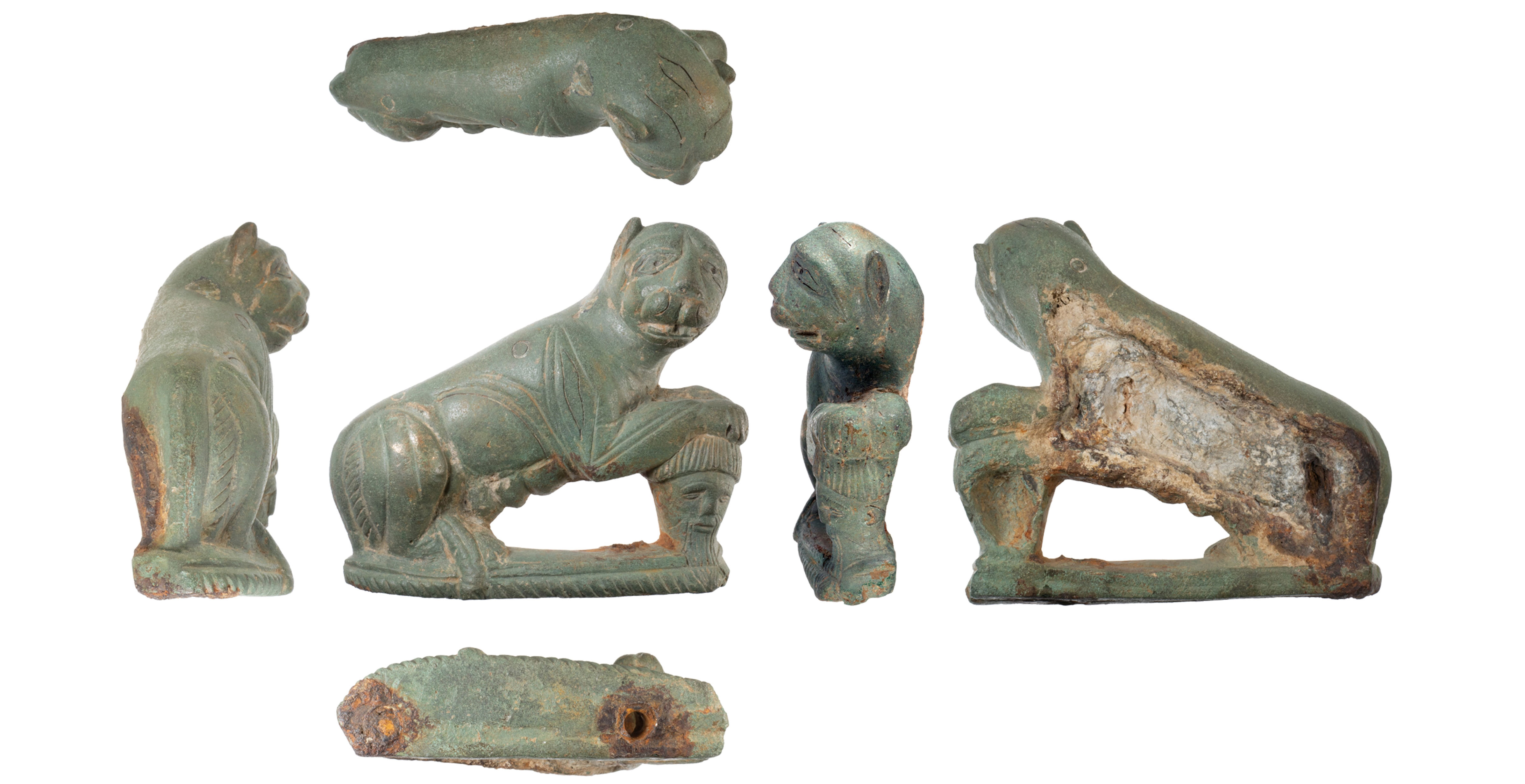 This rare Roman figurine of a cat with its paws atop a severed head is ...