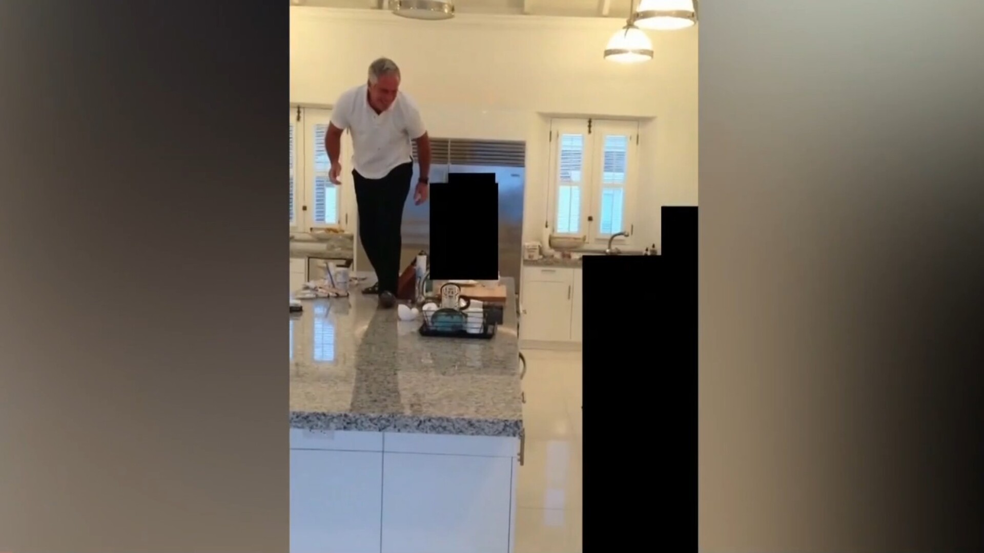 Disturbing new video shows Epstein chasing women around the kitchen of ...