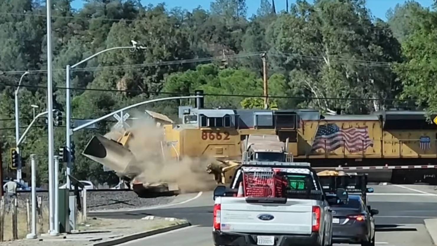 Tractor gets stuck on the tracks then a train hits at full speed