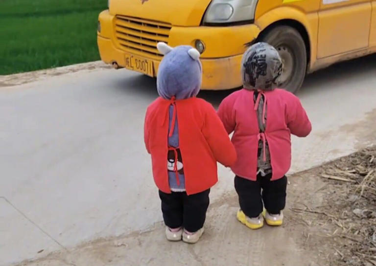 Twin sisters eagerly await older brother’s return home from school