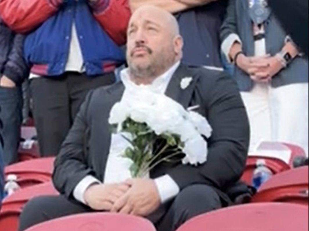 Kevin James sad and alone with a bouquet of flowers at the Super Bowl