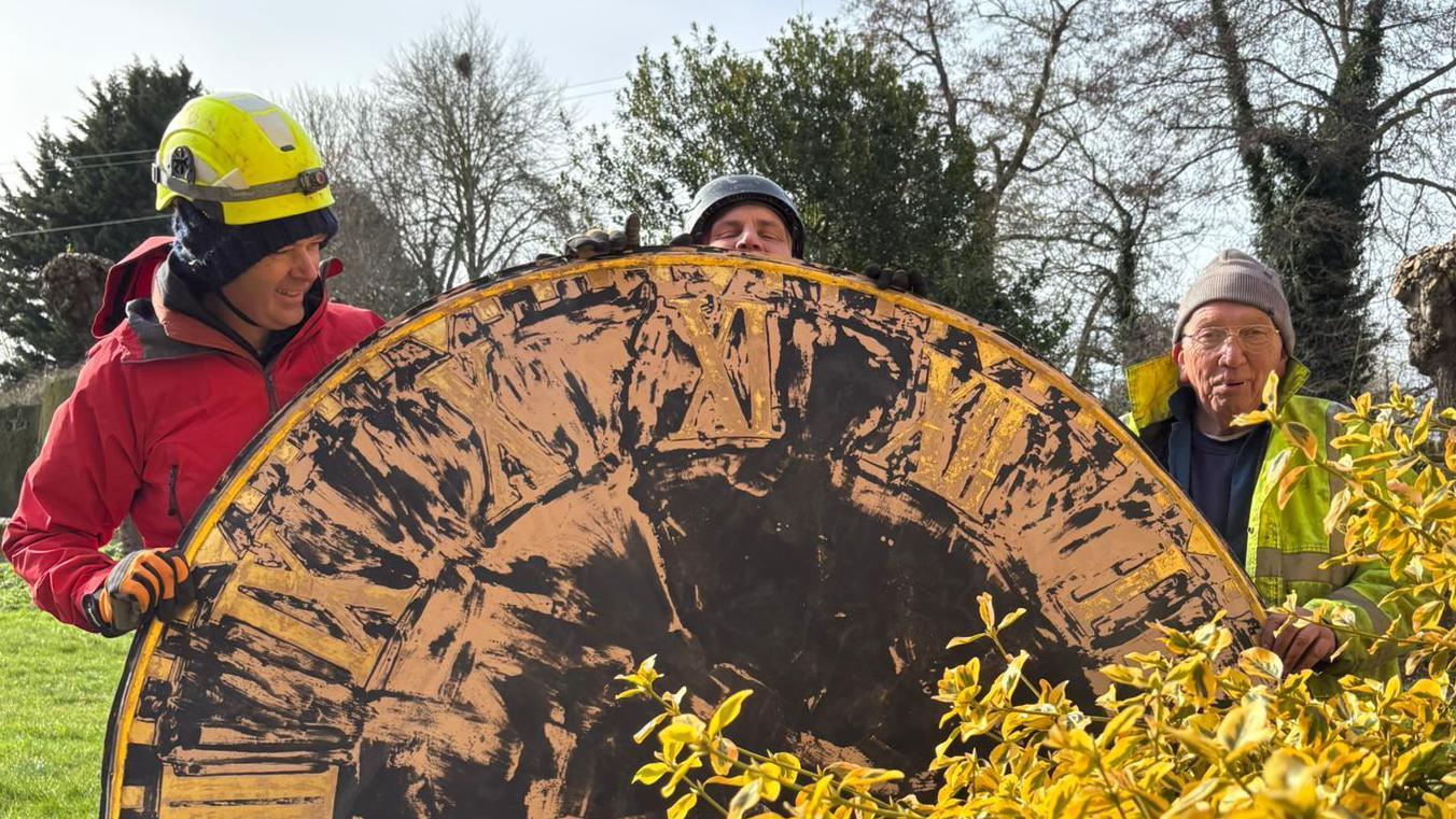 Centuries-old clock faces taken down for a repaint