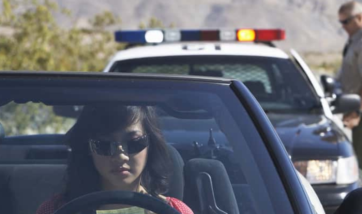 I hit a police car that suddenly veered left at a traffic light while ...