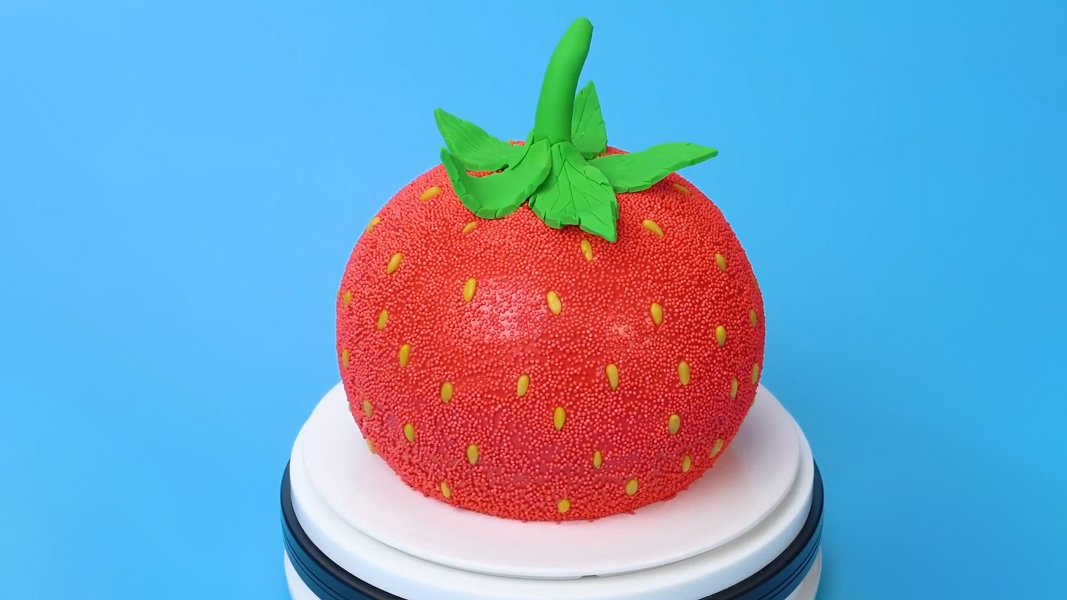 Strawberry shaped celebration cake