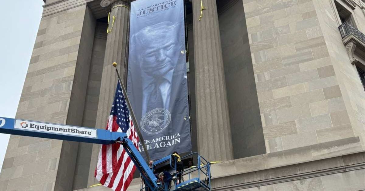 Giant Trump banner hangs outside Justice Department headquarters