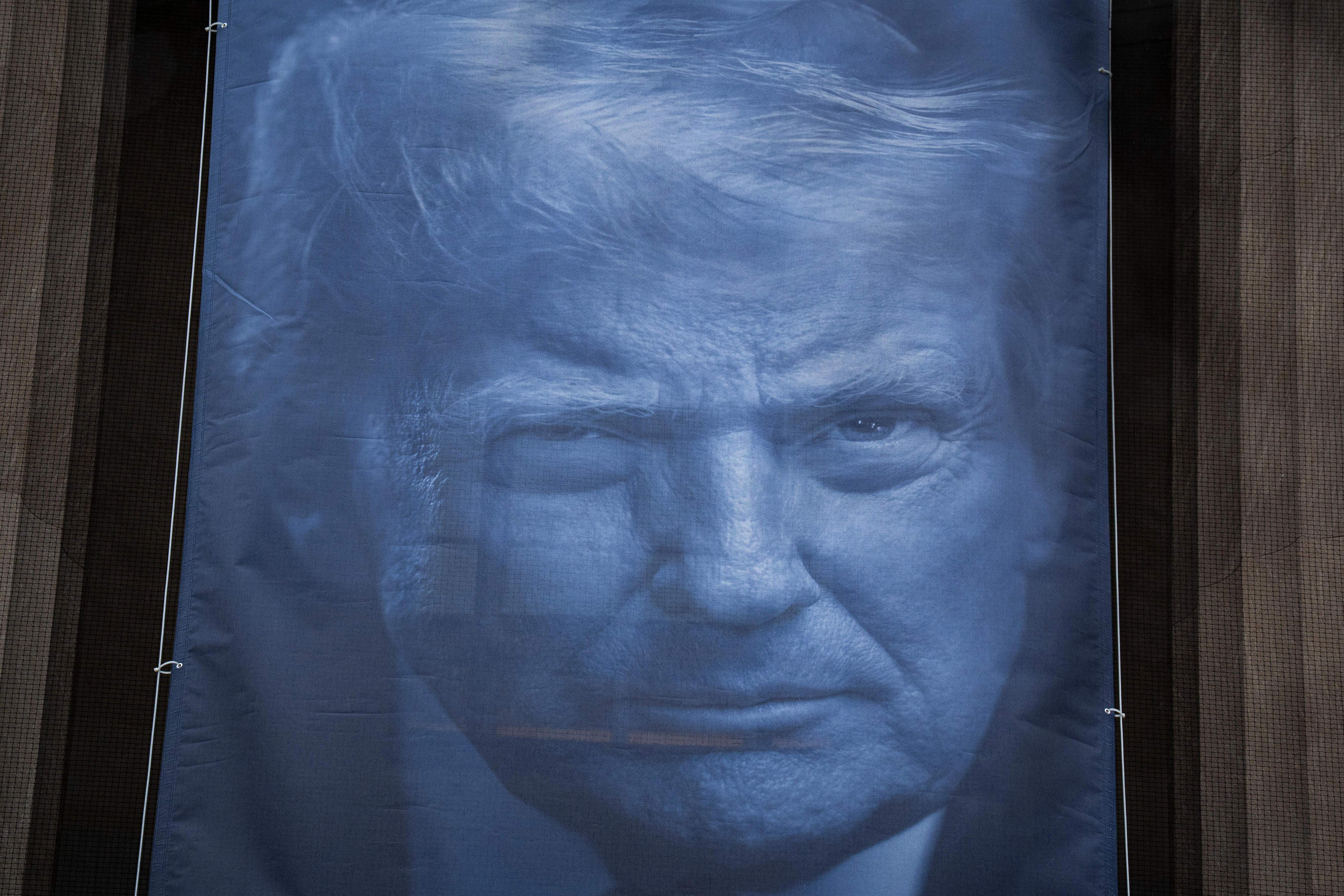 Democrats criticize giant Trump banner hung at DOJ