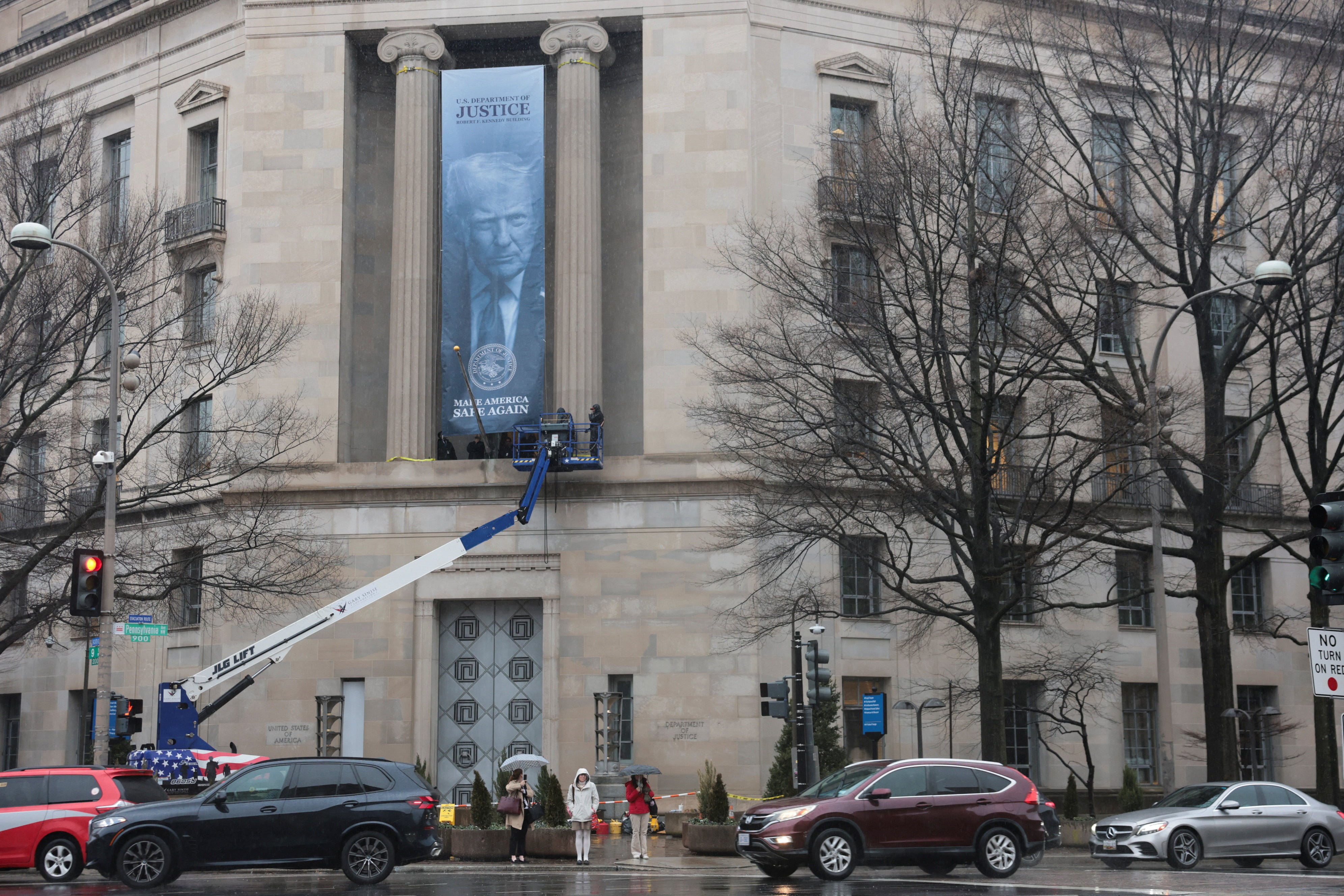 Banner of Donald Trump unfurled at Justice Department headquarters