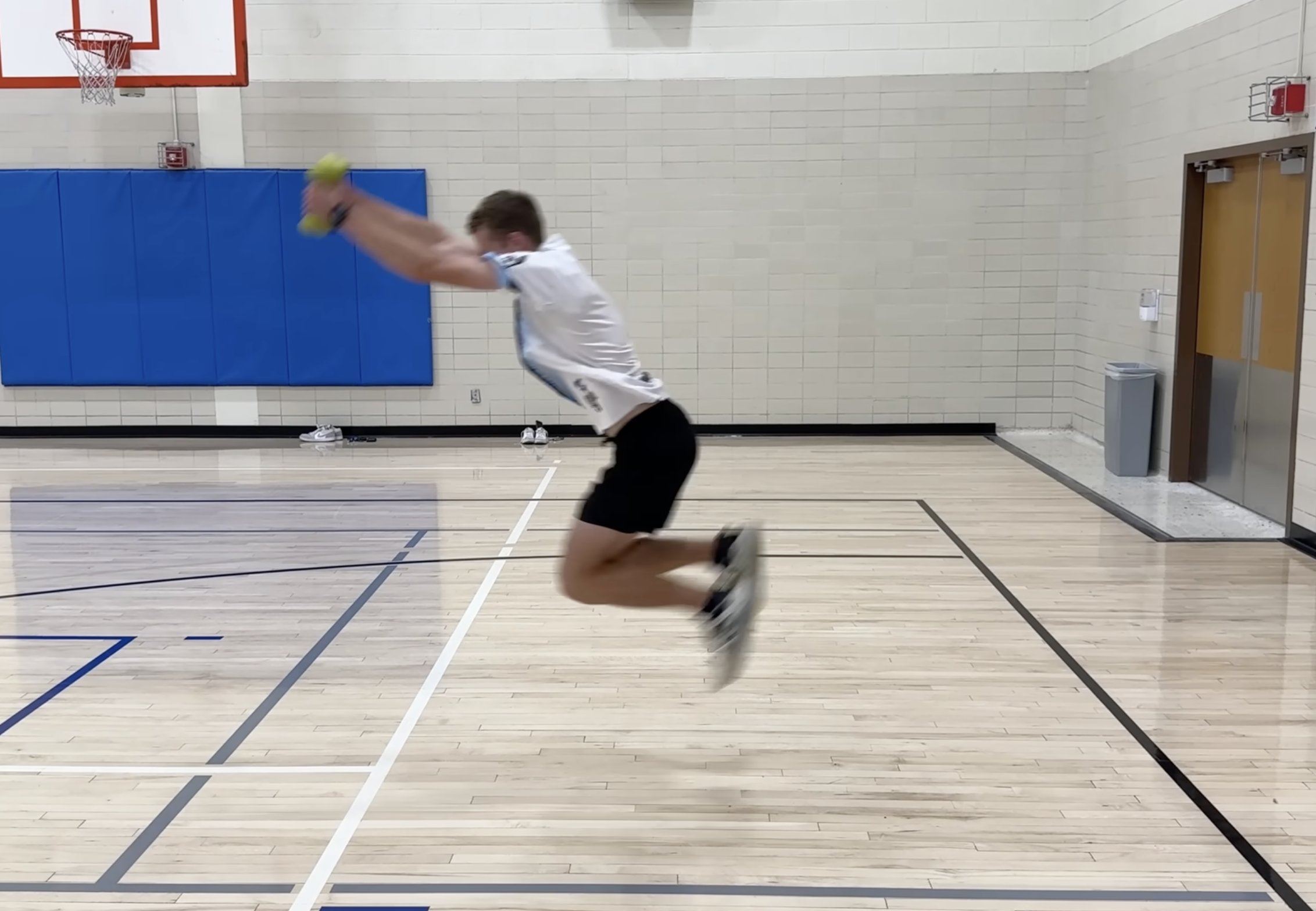 Why do you jump farther while holding weights?