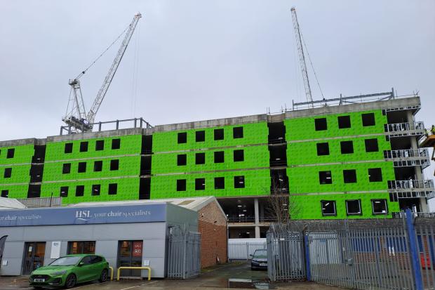 Massive laboratory buildings overshadow residents