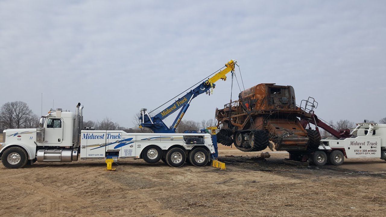 Loading a damaged farm combine